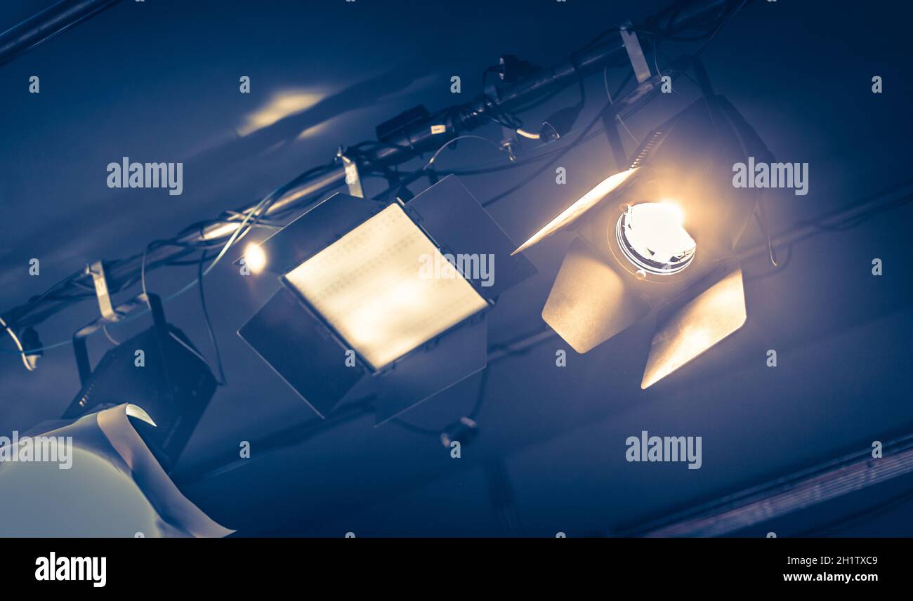 Professional orange studio spotlight hanging on the ceiling Stock Photo ...