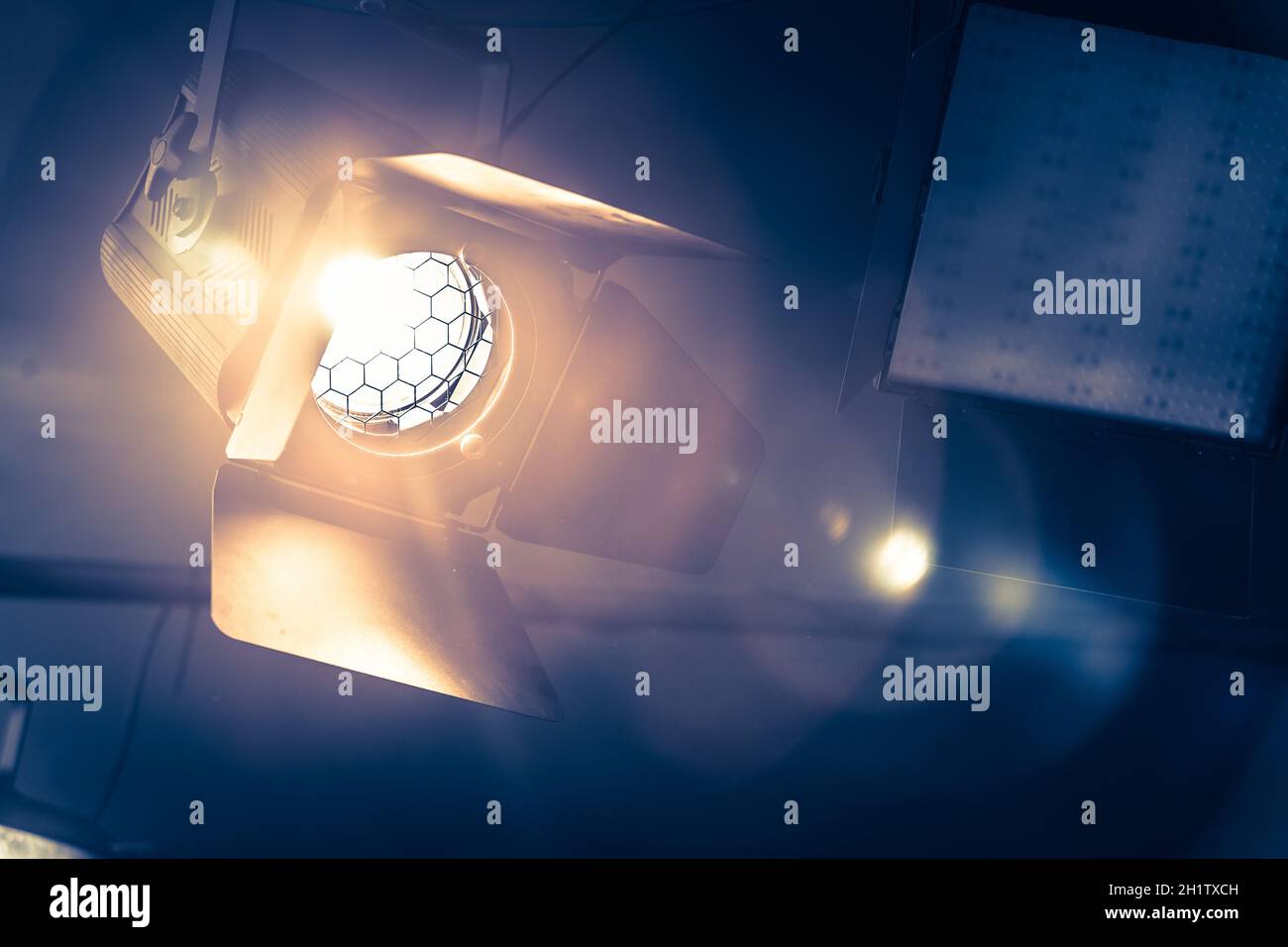 Professional orange studio spotlight hanging on the ceiling Stock Photo ...