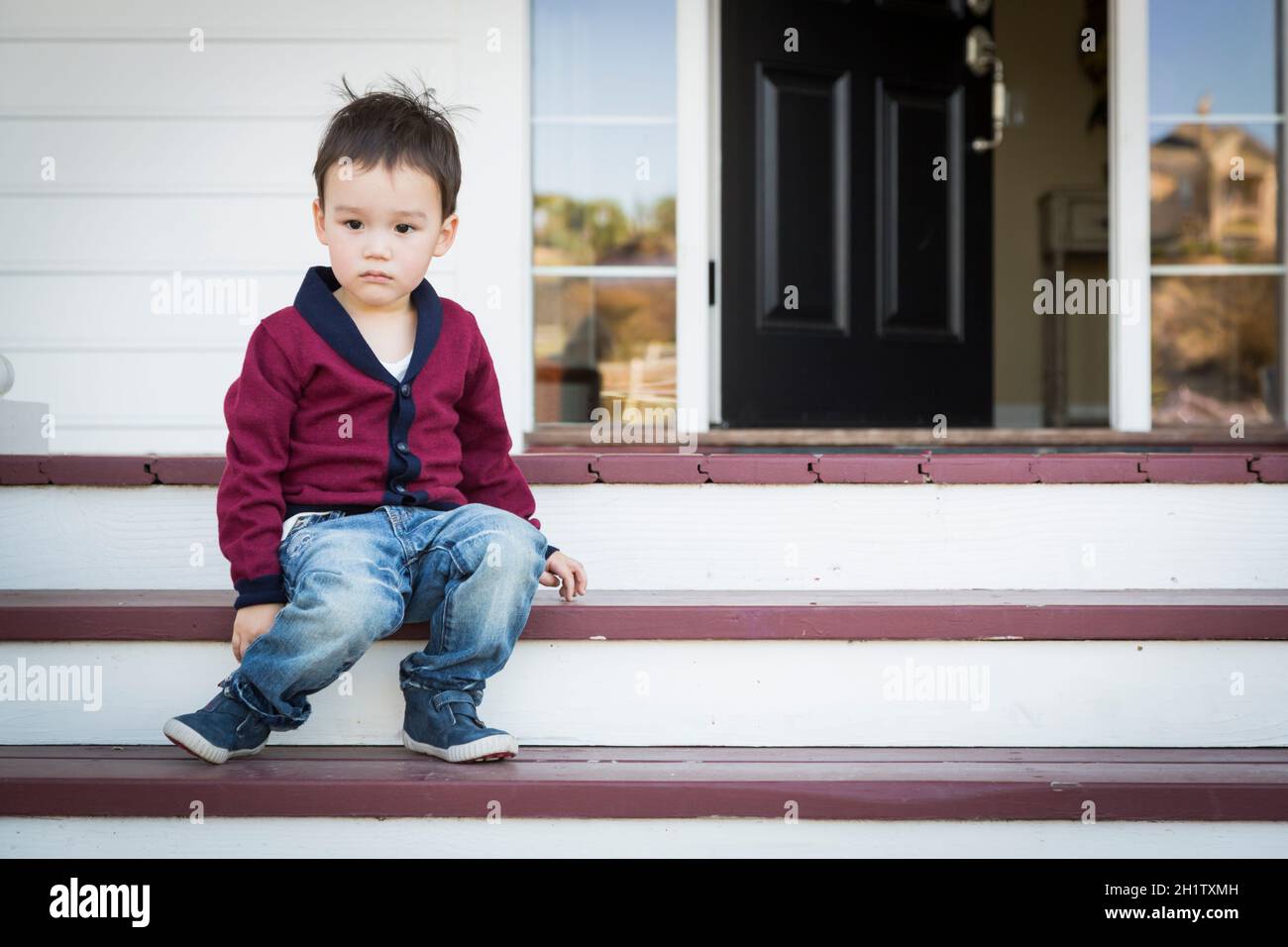 Cute Melancholy Mixed Race Boy Sitting on Front Porch Steps Stock Photo ...