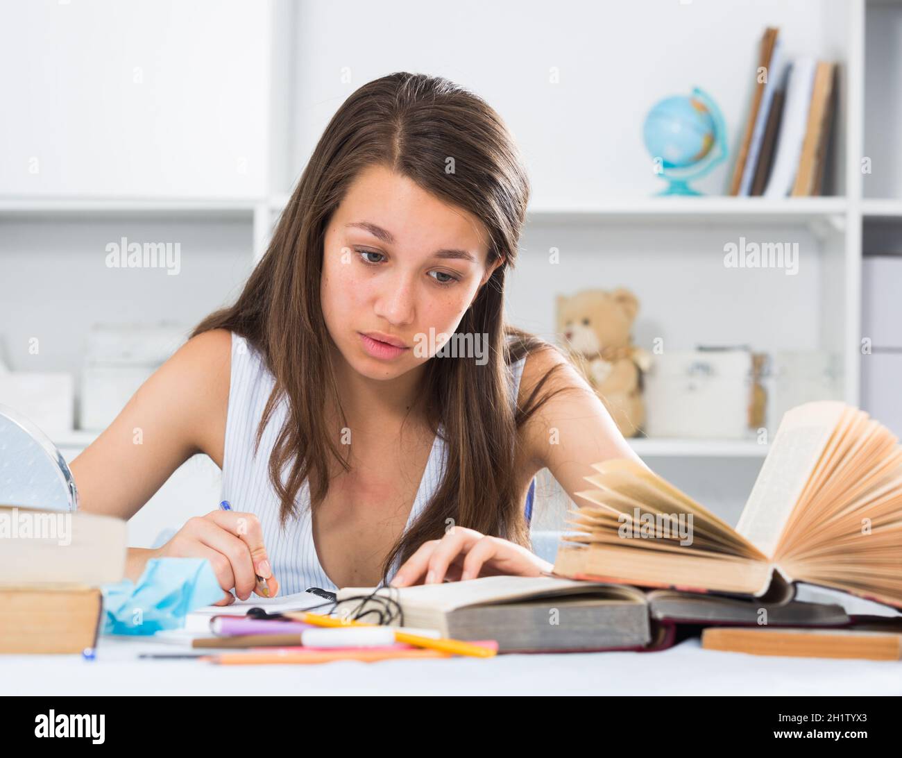 Female teenager is writing a review of novel Stock Photo - Alamy