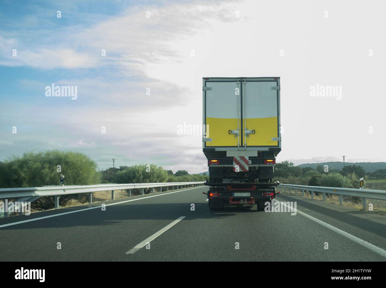Heavy tow truck carrying semi-trailer truck on freeway. Truck Height ...