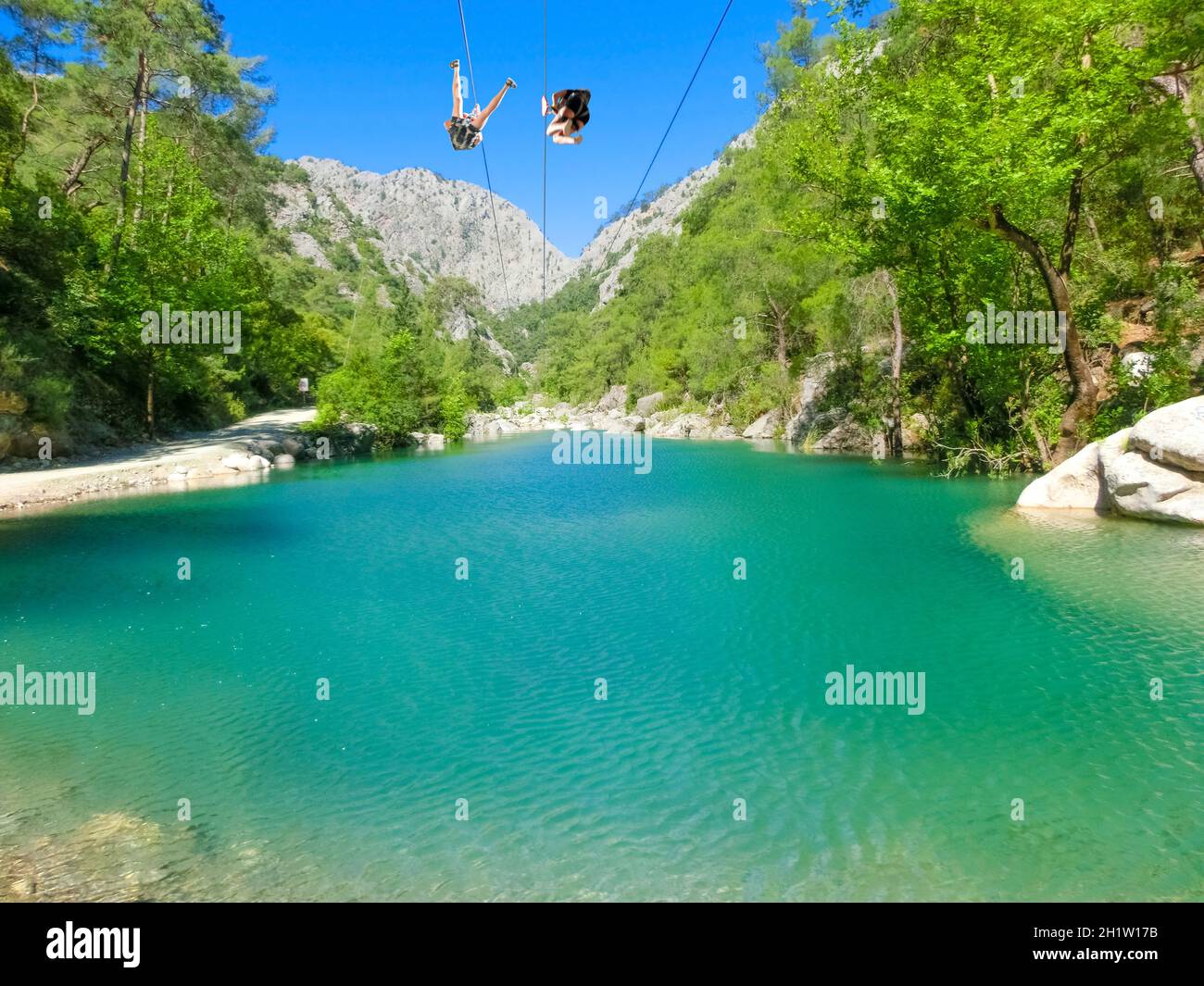 Tourist sliding on a zip line in the canyon of Harmony, near the town ...