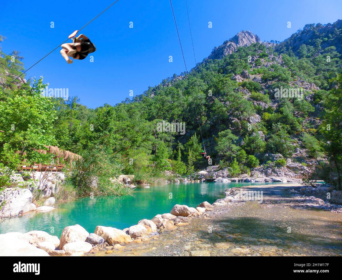 Tourist sliding on a zip line in the canyon of Harmony, near the town ...