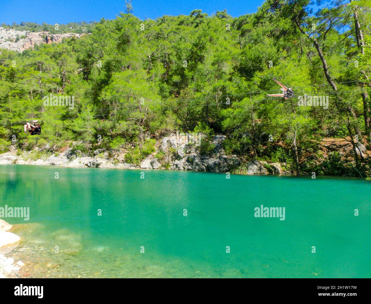 Tourist sliding on a zip line in the canyon of Harmony, near the town ...
