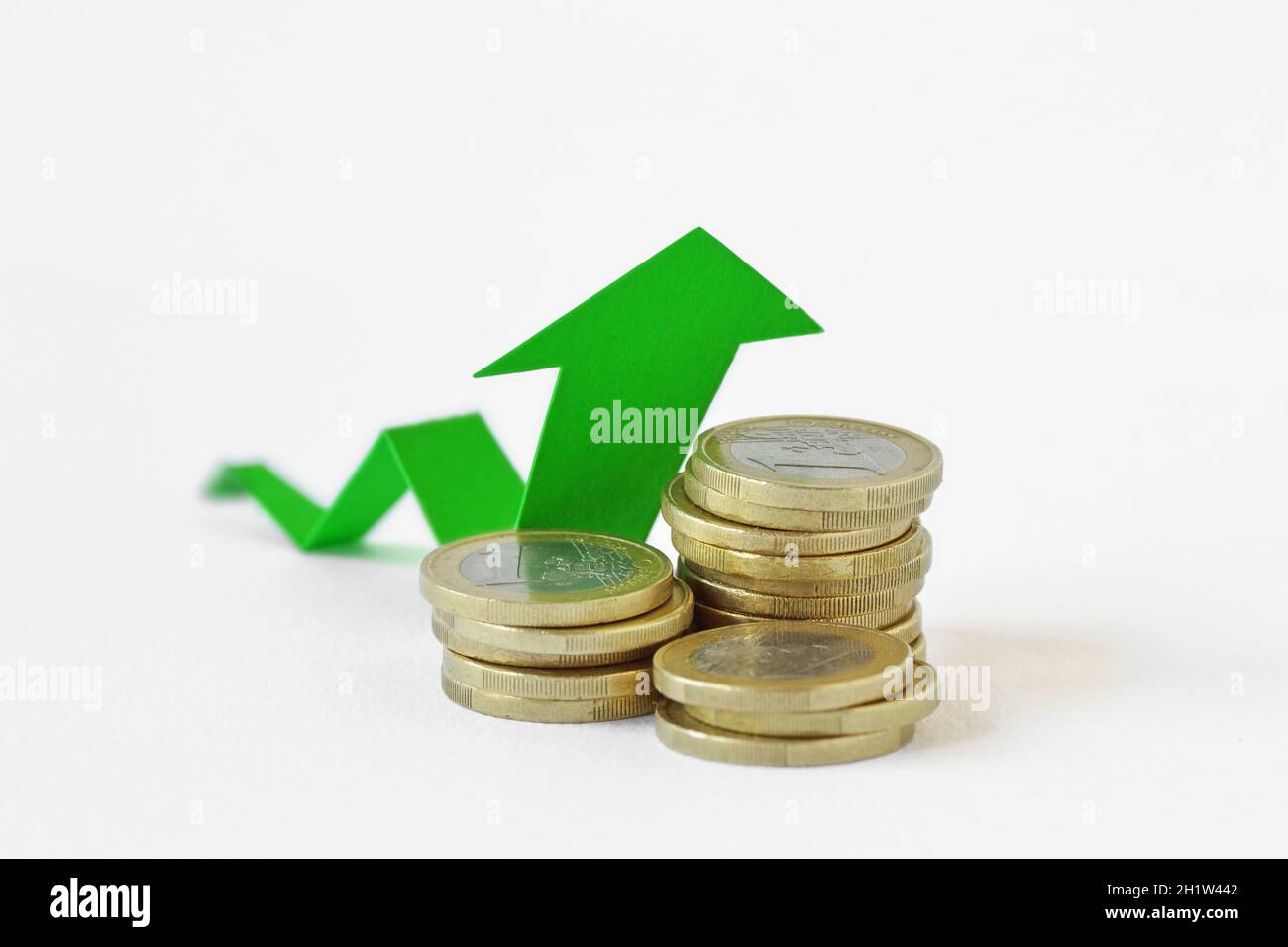 Piles of euro coins with green raising arrow - Money growth concept ...