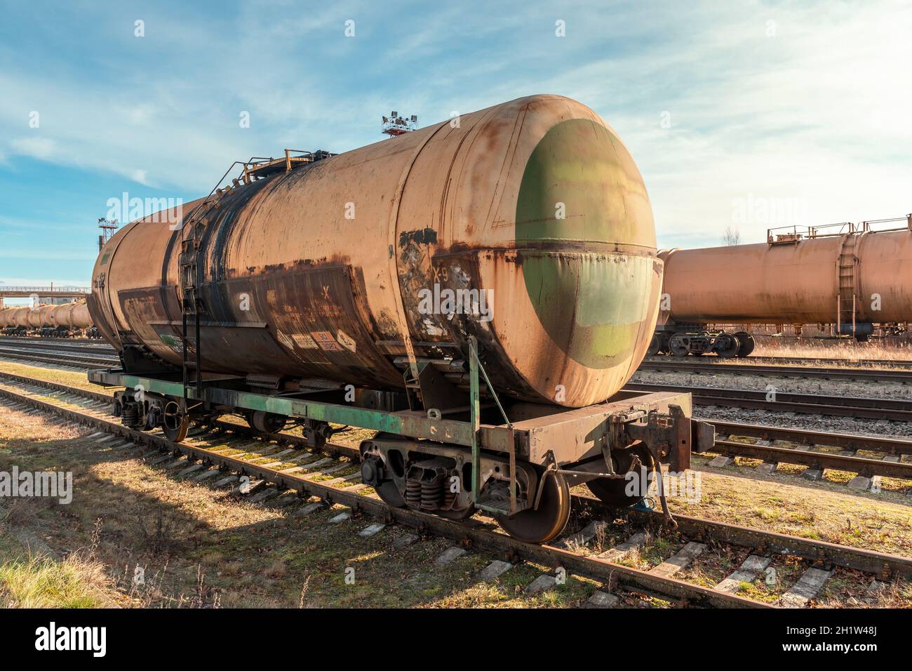 Grunge petroleum waggon on the railroad. Train delivering oil or gas ...