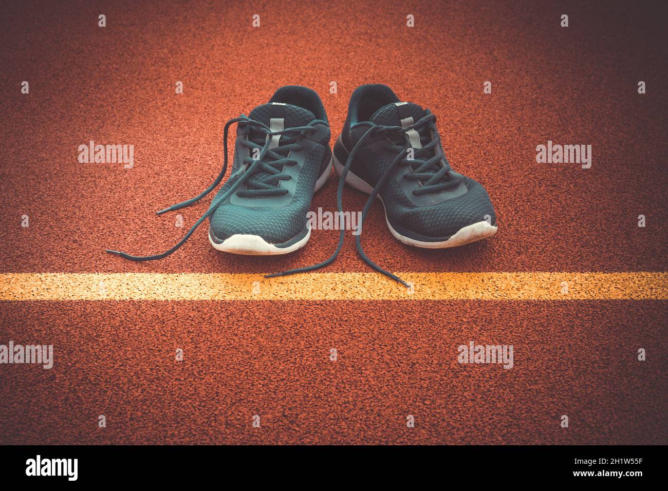 Running shoes on the start line on running track in the stadium Stock ...