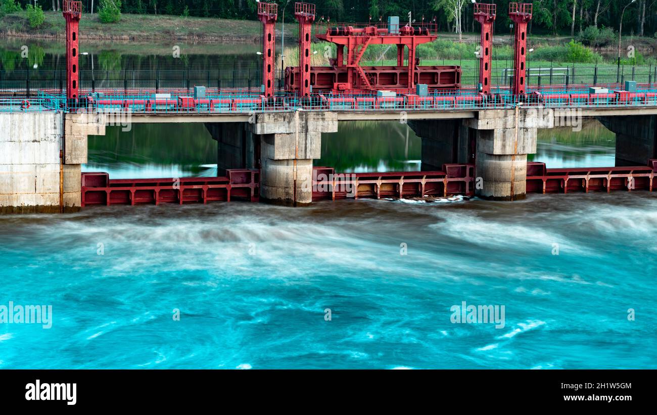 River, dam, bridge. Car and pedestrian bridge in the morning. A full ...