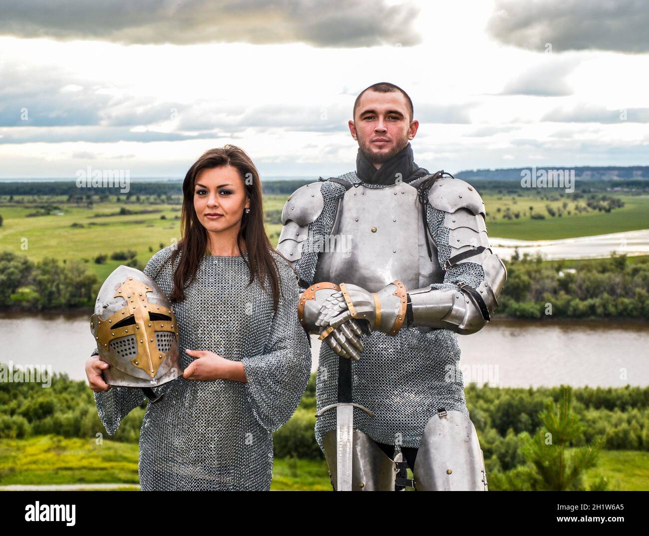 Knight with his lady in armor and chain mail. Knightly armor and weapon ...