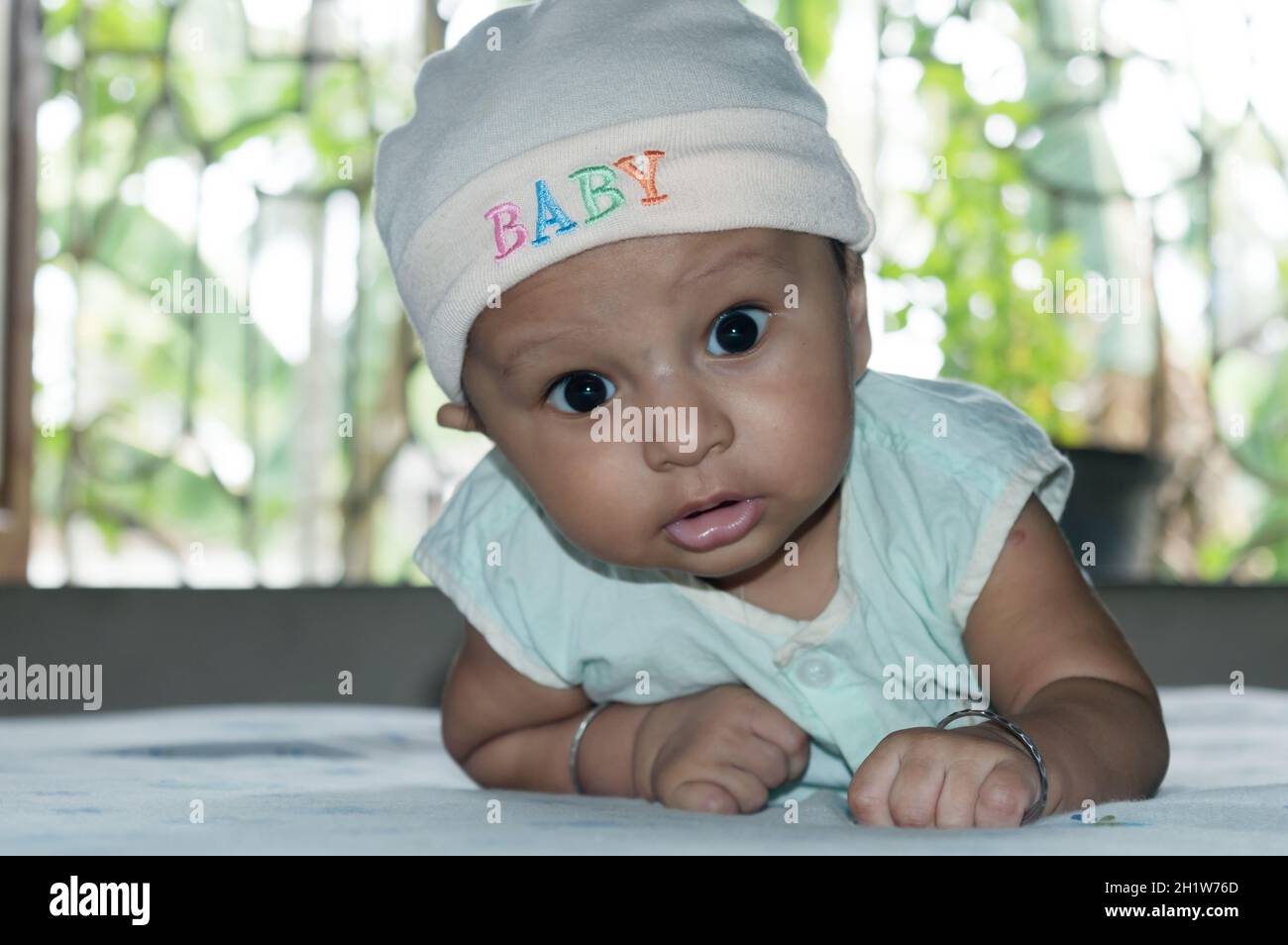 Cute baby lifting head. Closeup portrait. Happy baby boy looking and ...