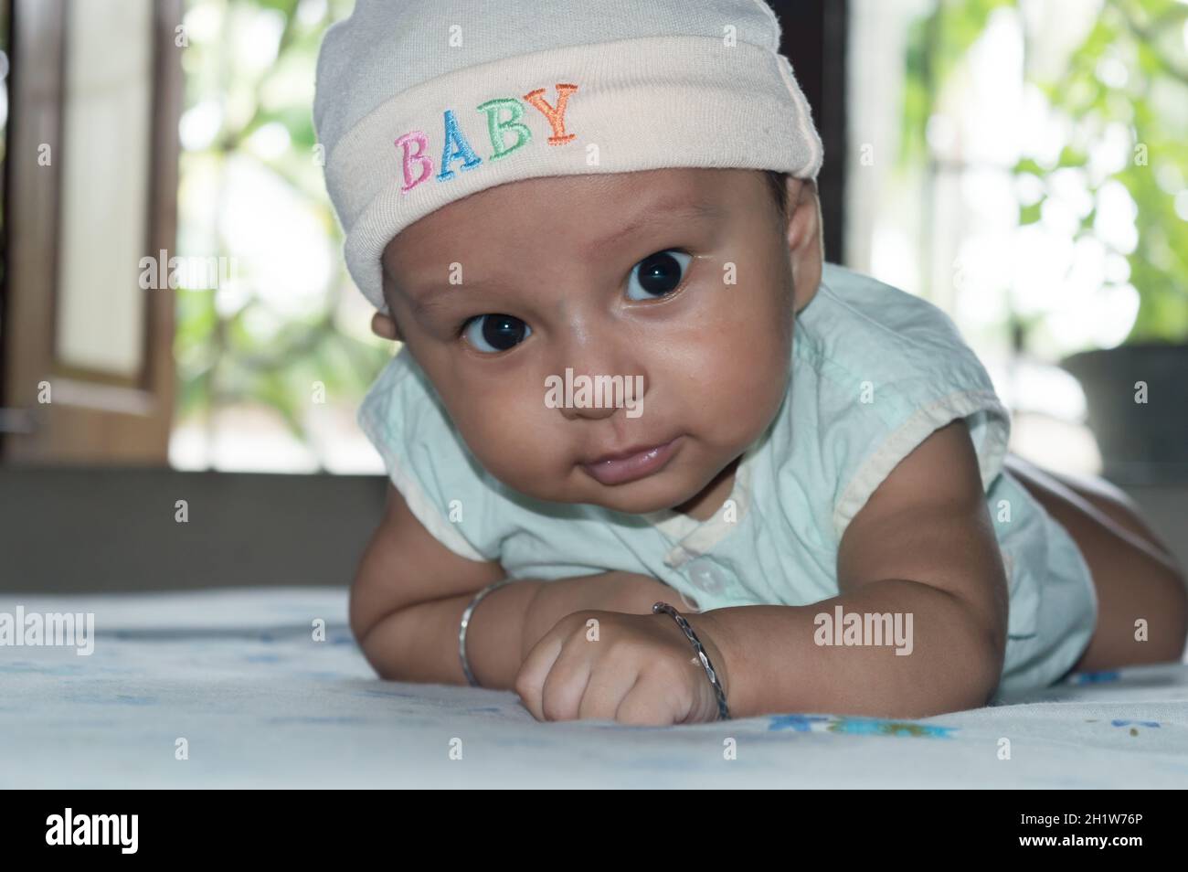 Cute baby lifting head. Closeup portrait. Happy baby boy looking and ...