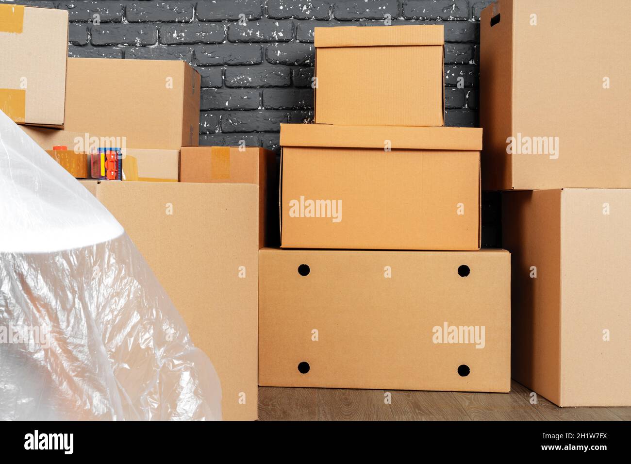 Moving in or moving out concept. Stack of boxes and packed furniture ...