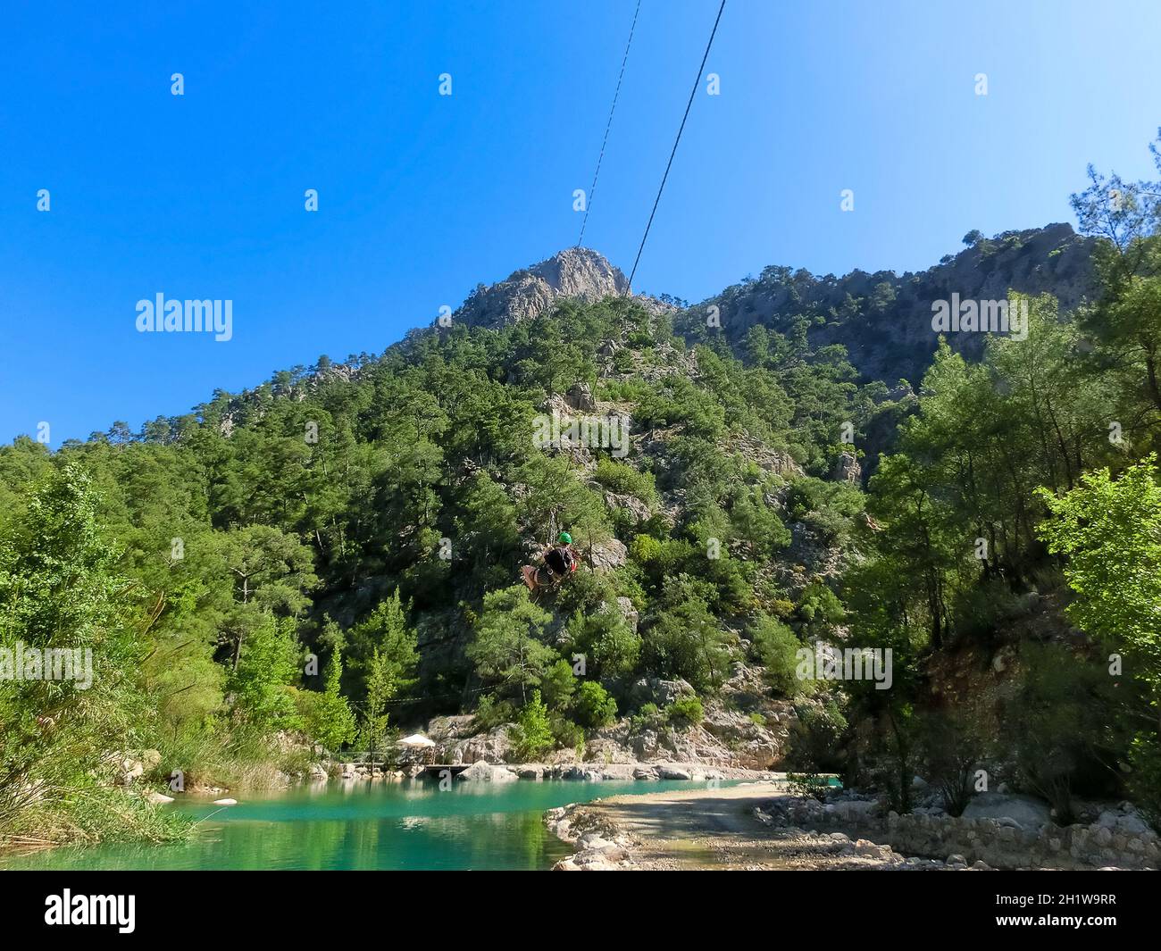 Tourist sliding on a zip line in the canyon of Harmony, near the town ...