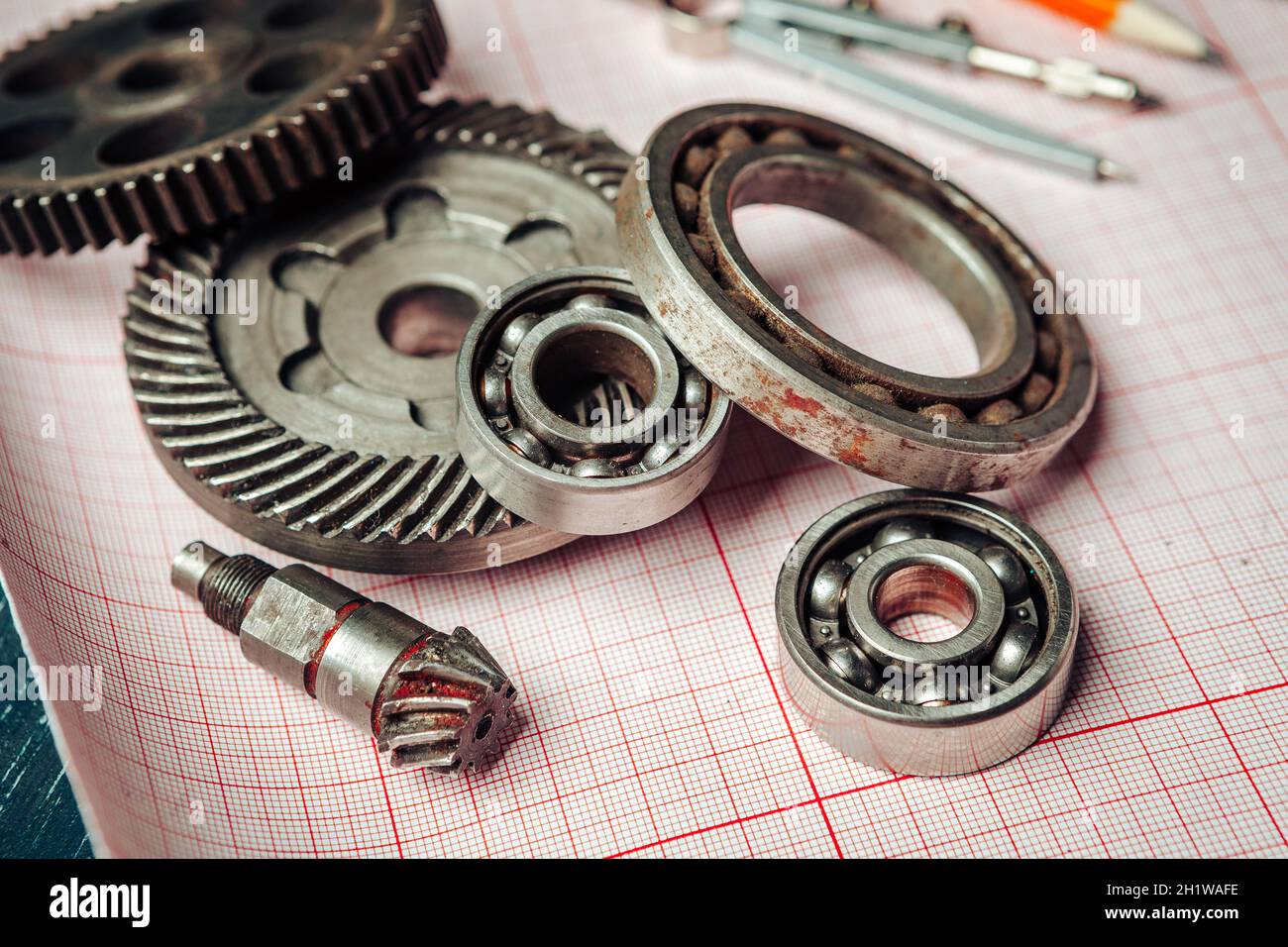 Car parts on graph paper close up. Engineering concept Stock Photo - Alamy