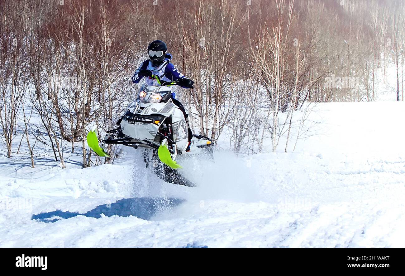 The Snowmobile in high jump above track Stock Photo - Alamy