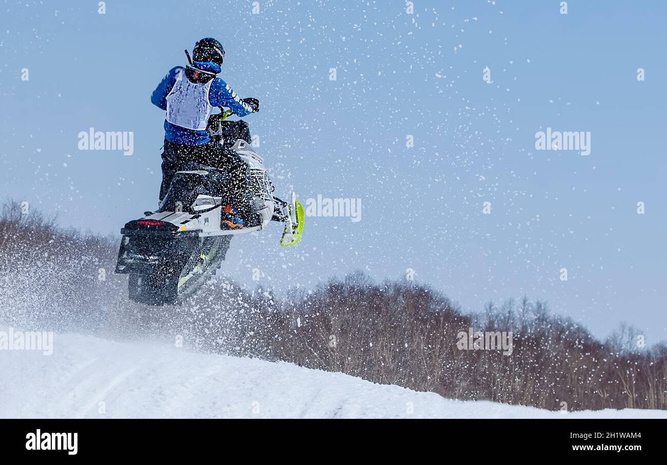 The Snowmobile in high jump above track Stock Photo - Alamy