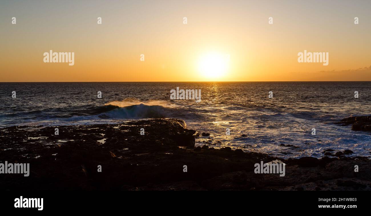 Evening scene on sea, stones, calm ocean Stock Photo - Alamy