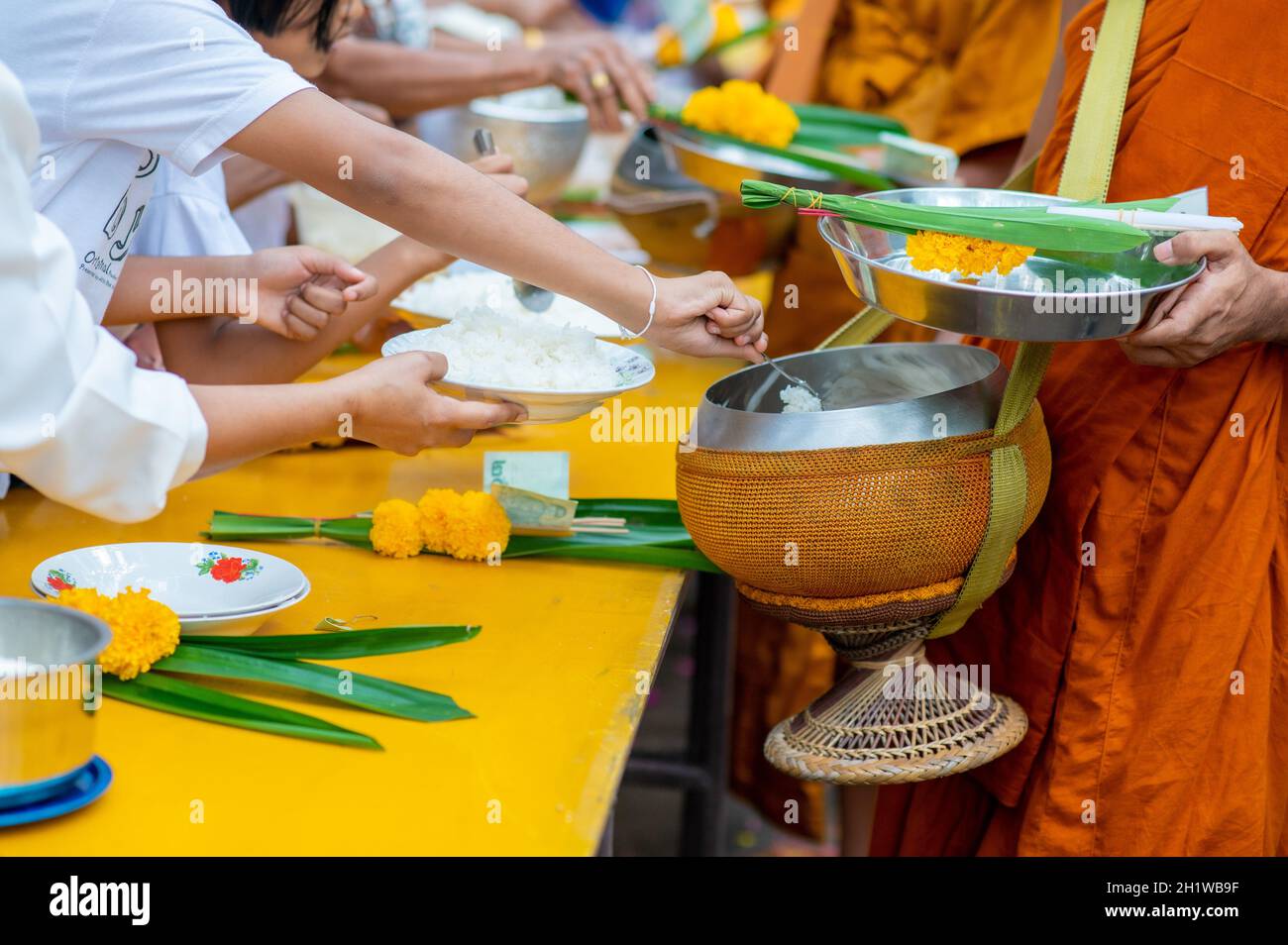 Alms round The yellow robes of monks walk on alms round as a Buddhist ...