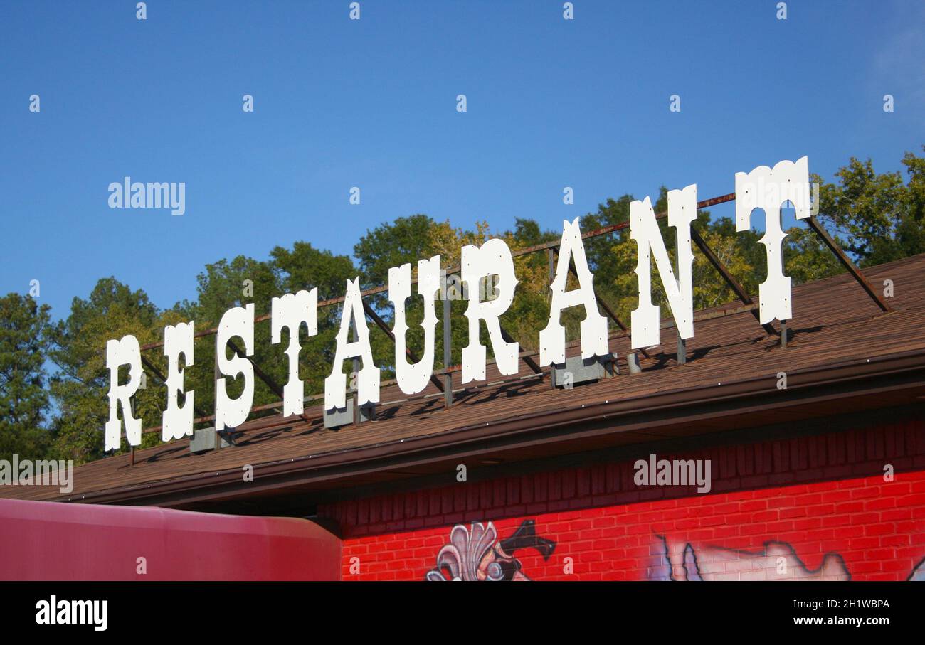 Restaurant Sign on Building Roof Stock Photo - Alamy