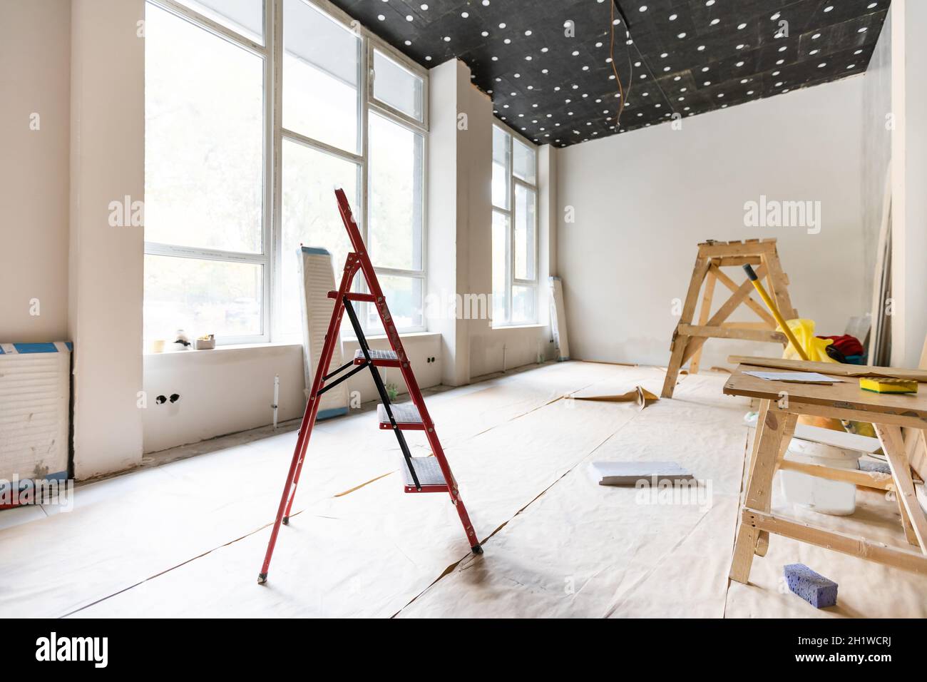 Repair and painting of walls in room Stock Photo - Alamy