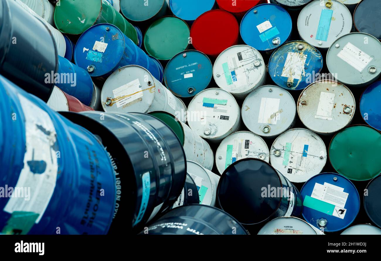 Old chemical barrels. Blue, red, and green chemical drum. Steel tank ...