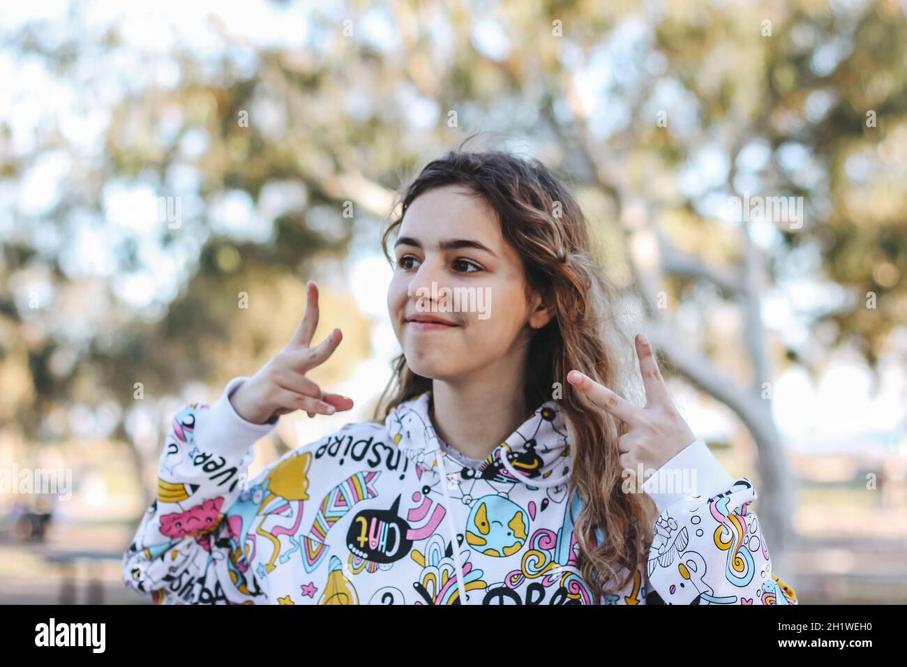Happy girl smiling and looking aside. Curly pretty teenager girl Stock ...