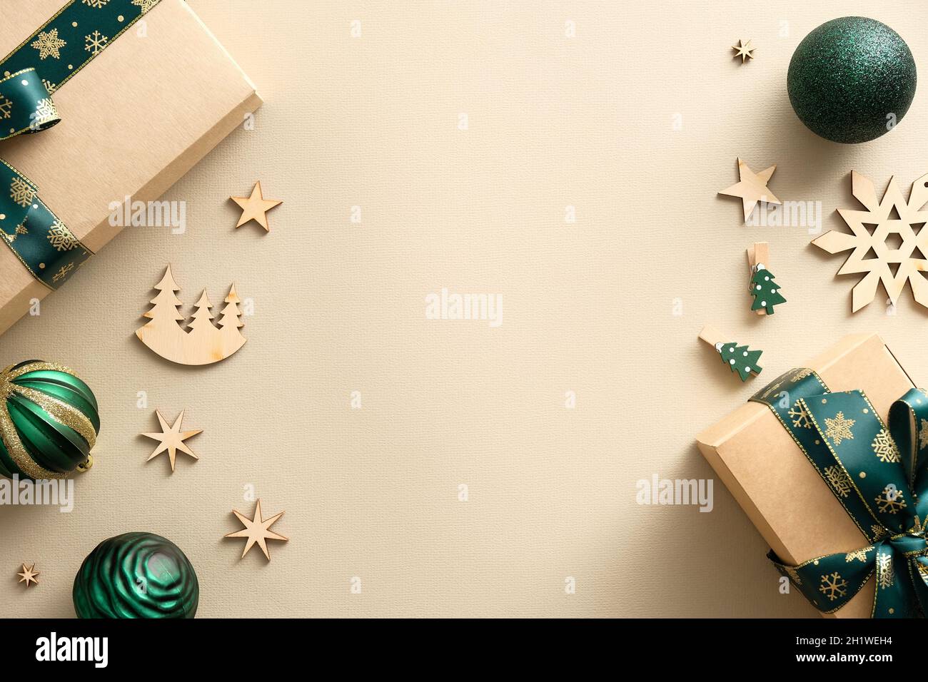 Winter Christmas composition with craft paper gifts, wooden decorations ...