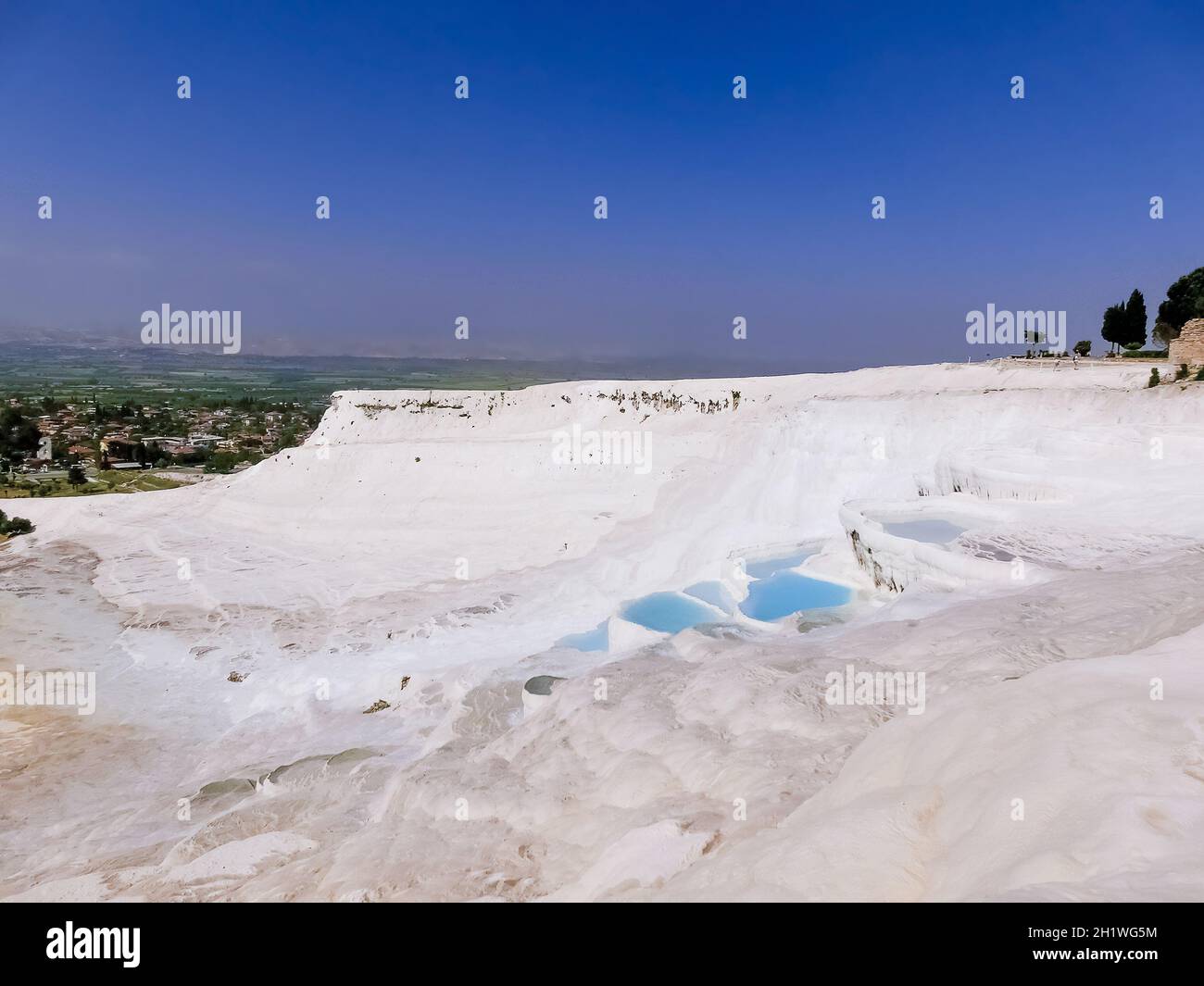 Travertines in Turkey. Calcite cliff of Pamukkale at sunny day Stock ...