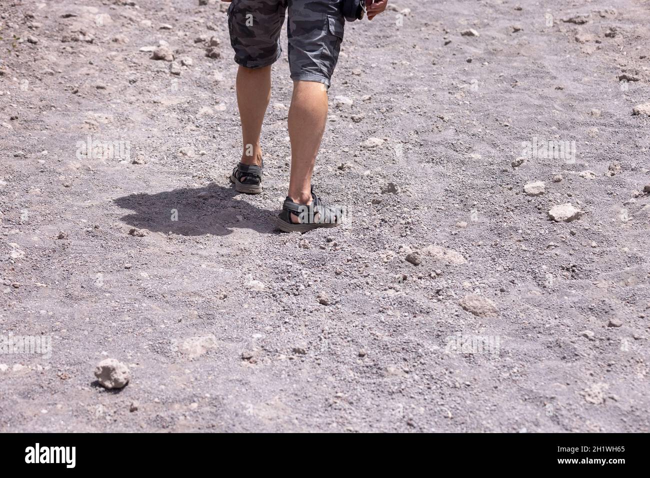 Tourist in sandals walking along the footpath to the top of Vesuvius ...