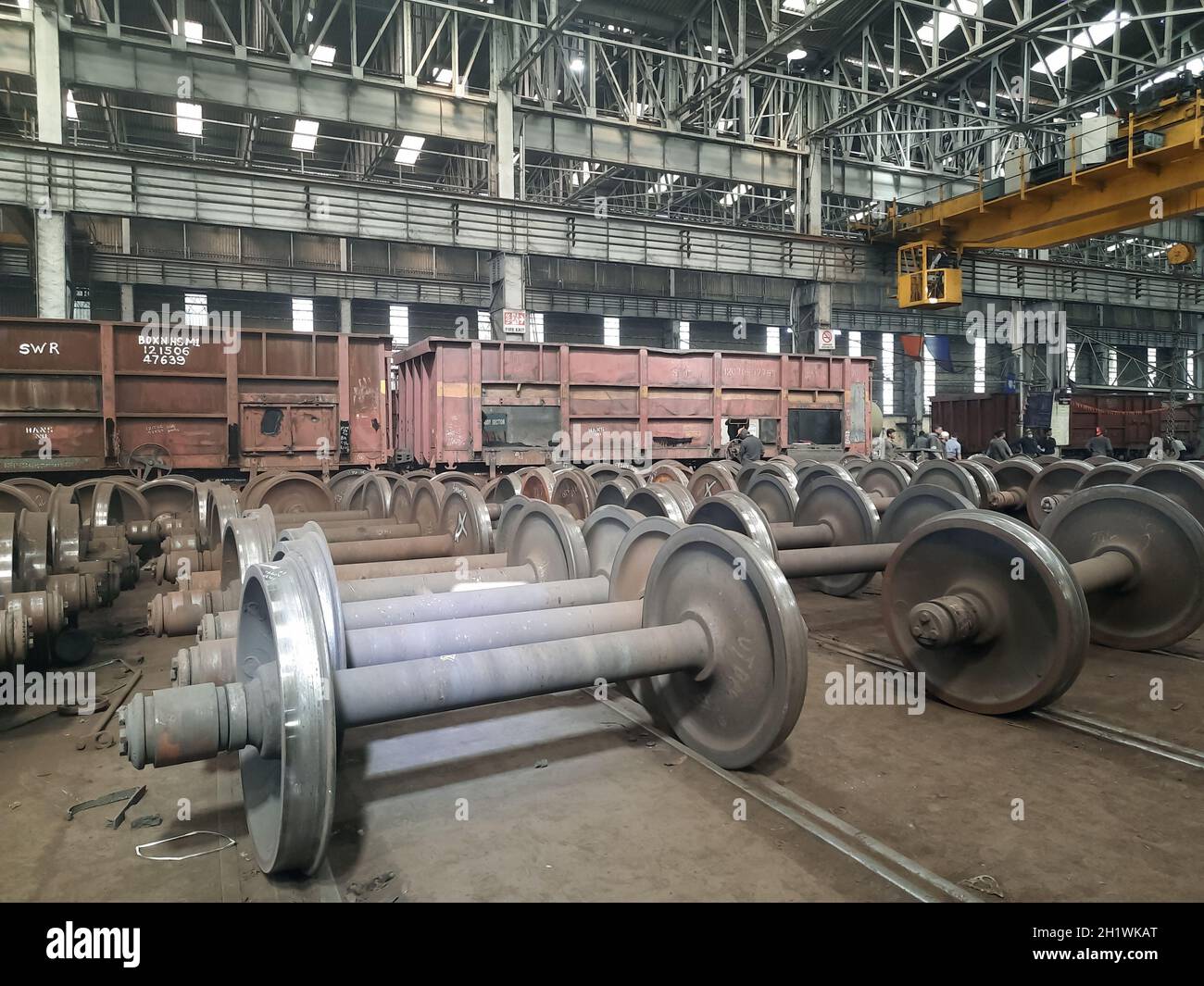 A closeup view of the wheels of a train, heavy industry factory ...