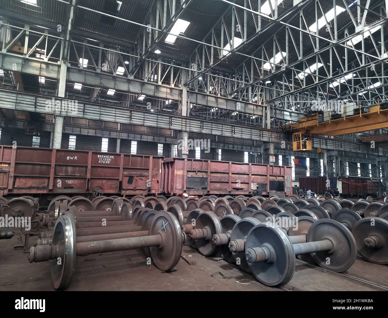 Spare railway wheels on the axle in a repair workshop Stock Photo - Alamy