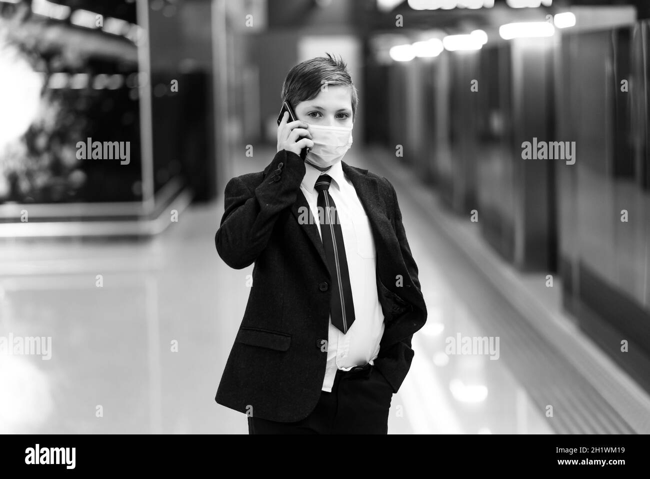 A boy in medical mask is sad at the train window, a child is traveling ...