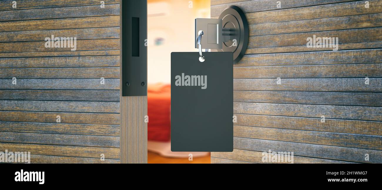 Door key with blank label in the keyhole. Key ring, room key and empty ...
