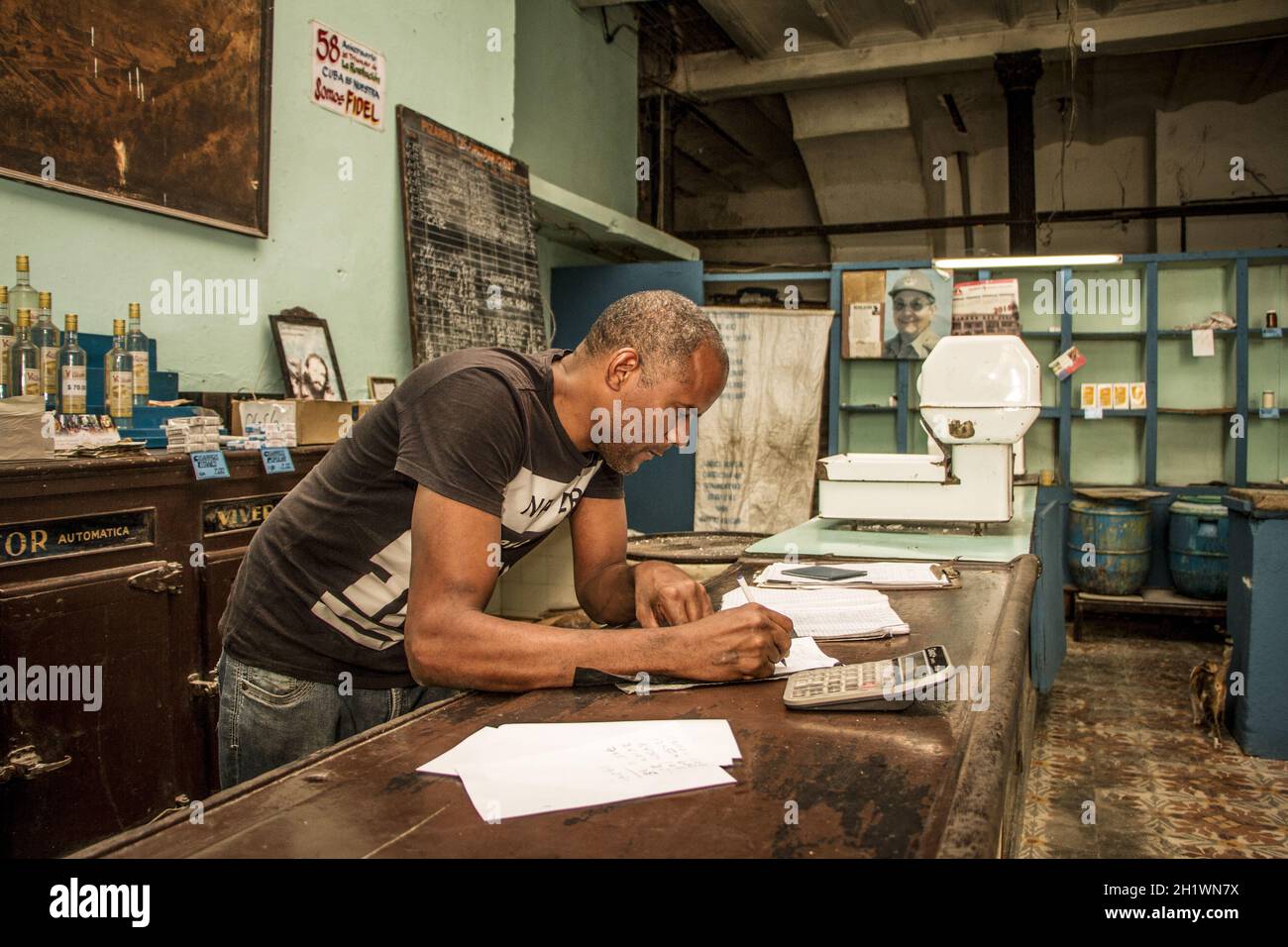 HAVANA, CUBA - Dec 31, 2016: A man working in a food store in Old ...