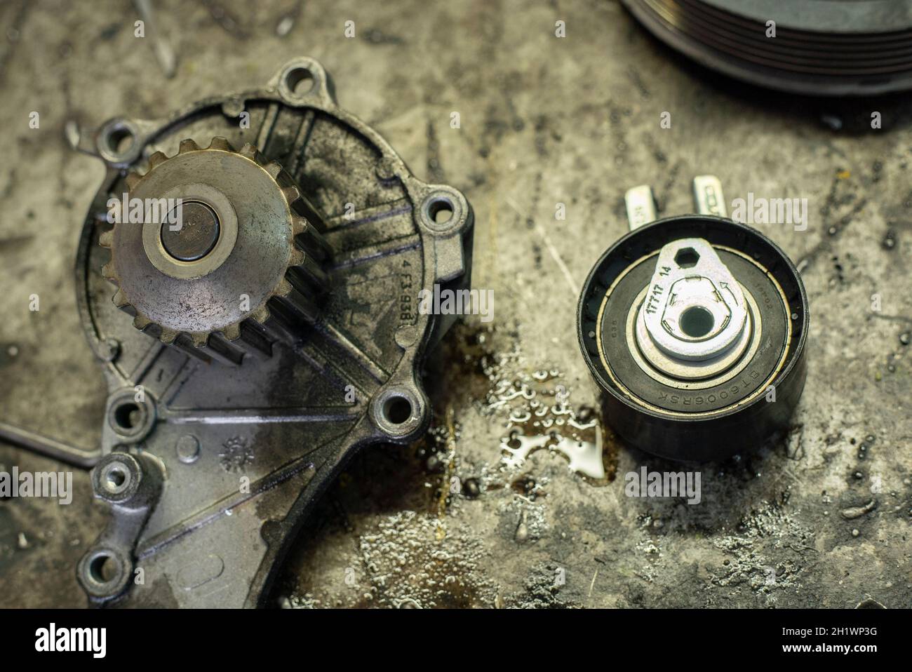 Old car engine parts in a workshop bench Stock Photo - Alamy