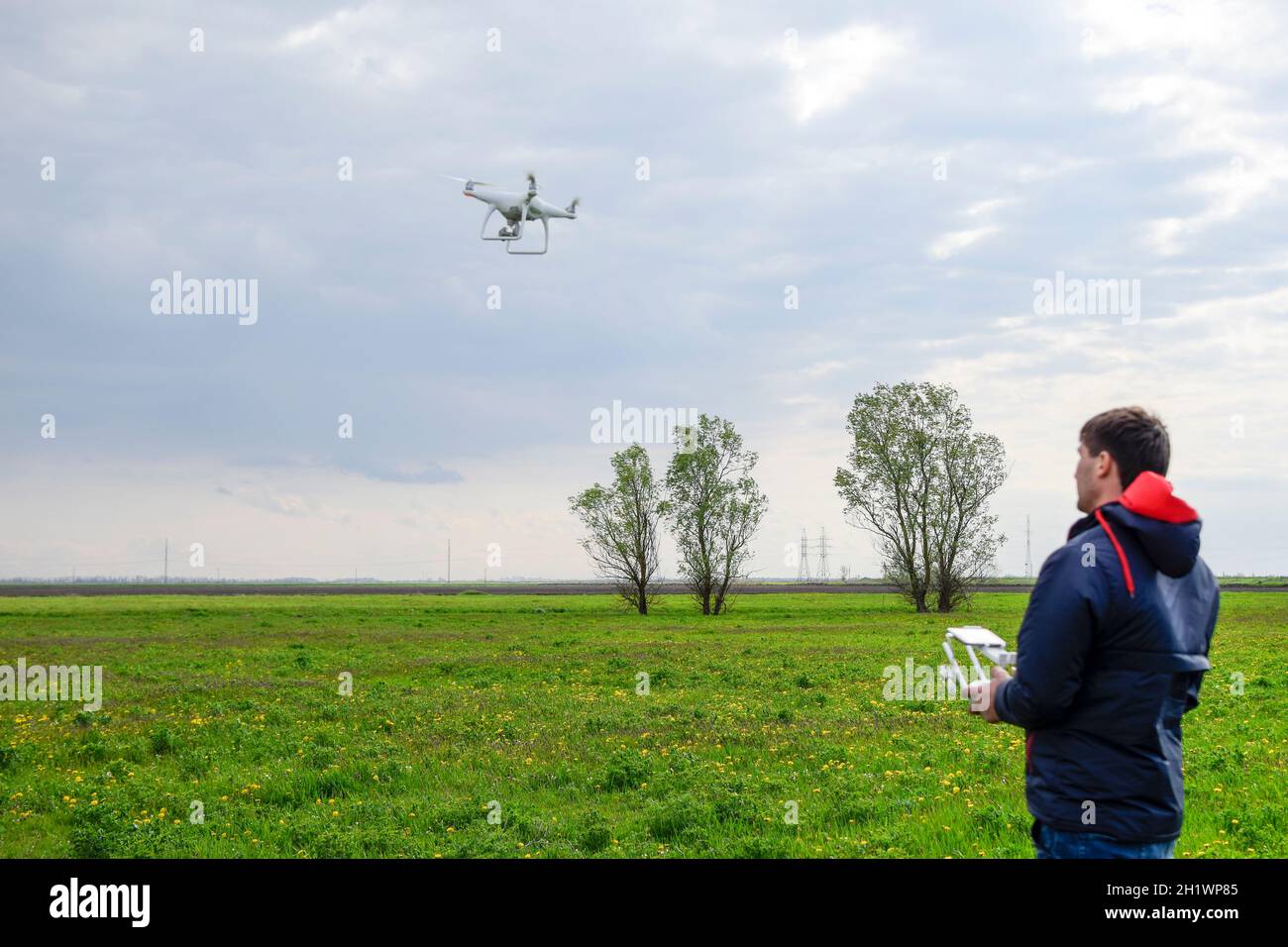 A man with a remote control in his hands. Flight control of the drone ...