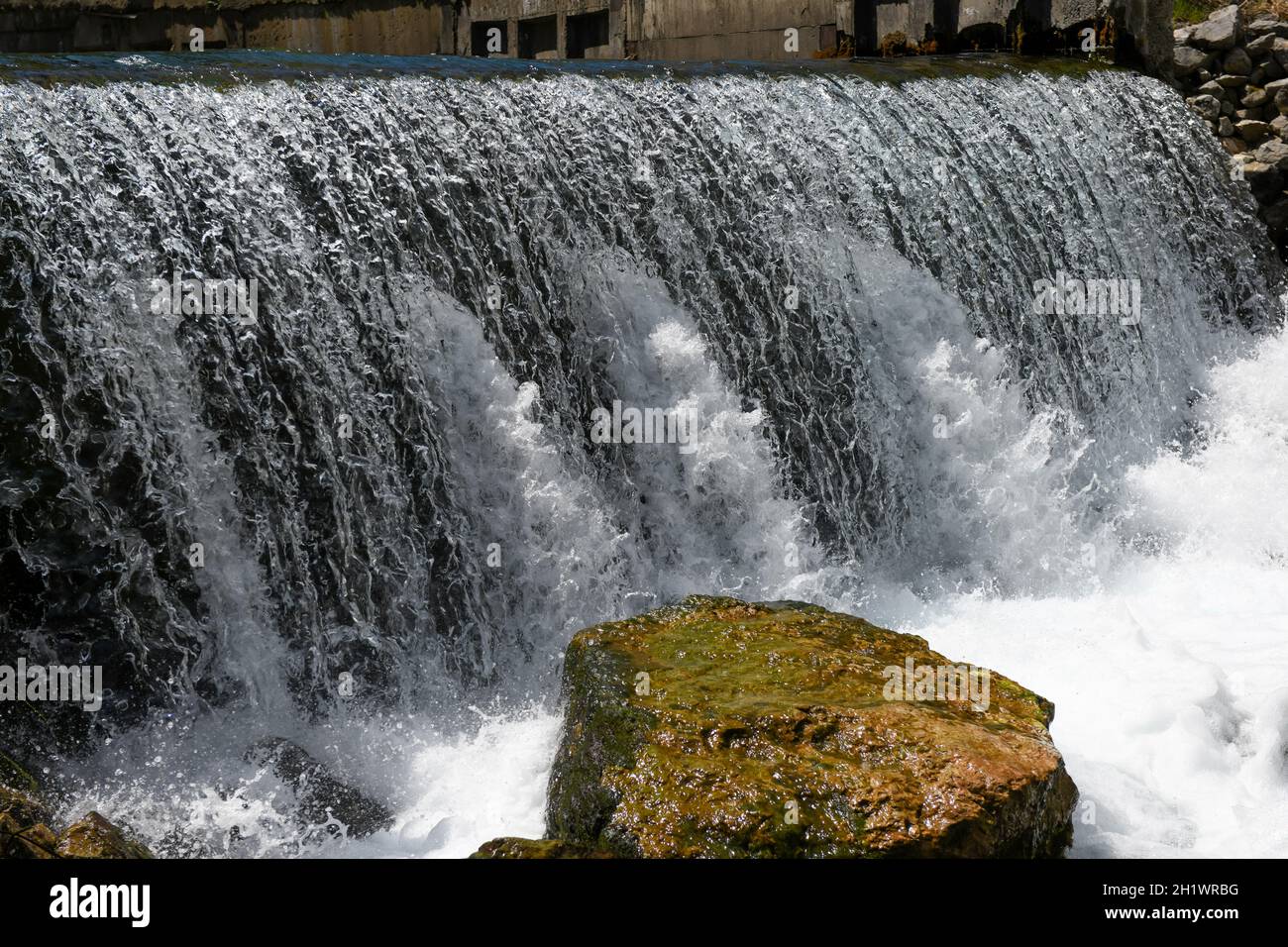 Waterfall on the dam. Splashes, jets of water. Fragment Stock Photo - Alamy