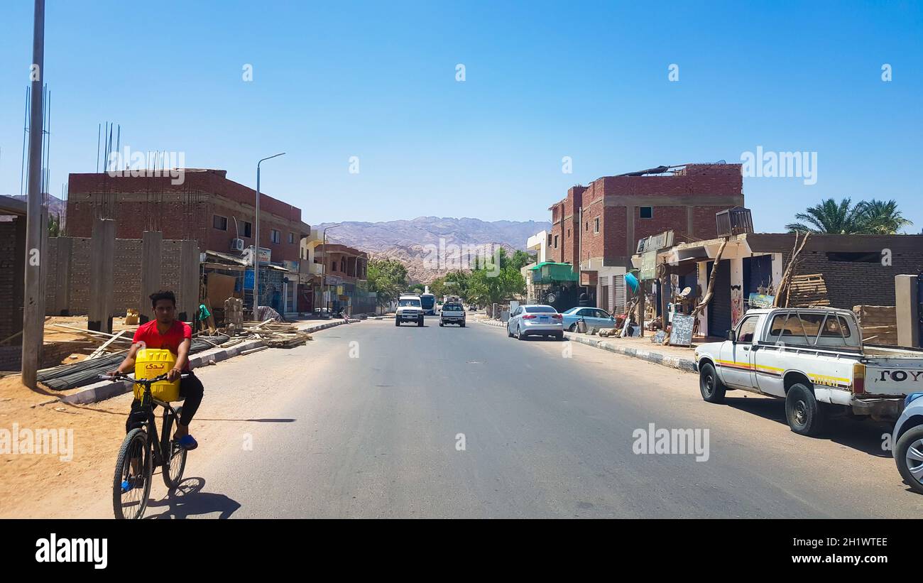 Egypt, Dahab - June 20, 2019: an Arab riding a bicycle along one of the ...