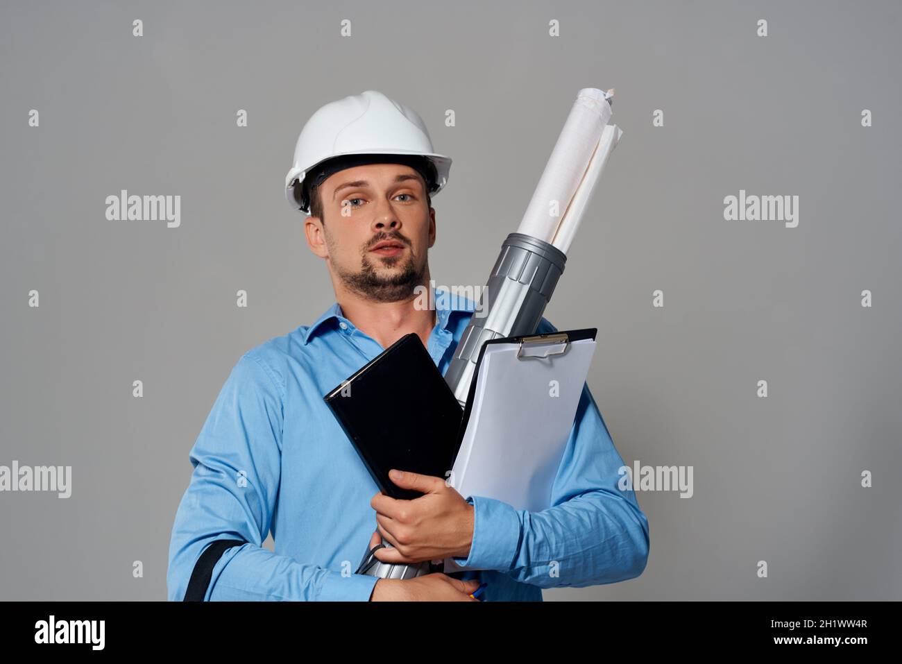 engineer with drawings in hand hand gesture light background Stock ...