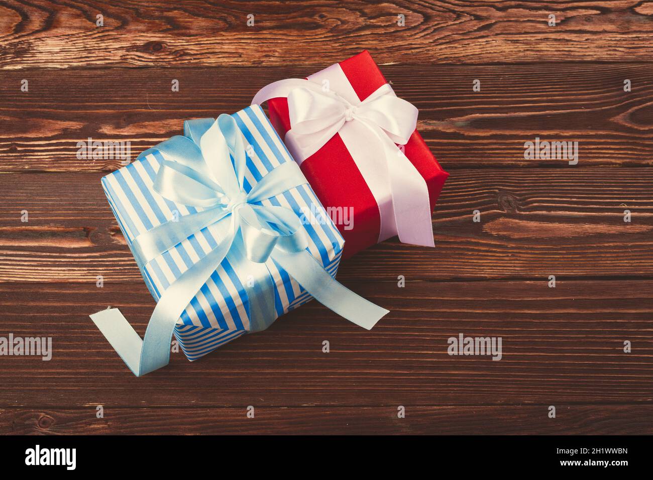 Brown wooden table with decorated gift boxes Stock Photo - Alamy