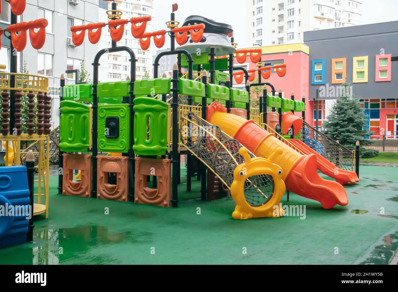 A courtyard of high-rise buildings with a new modern colorful and large ...