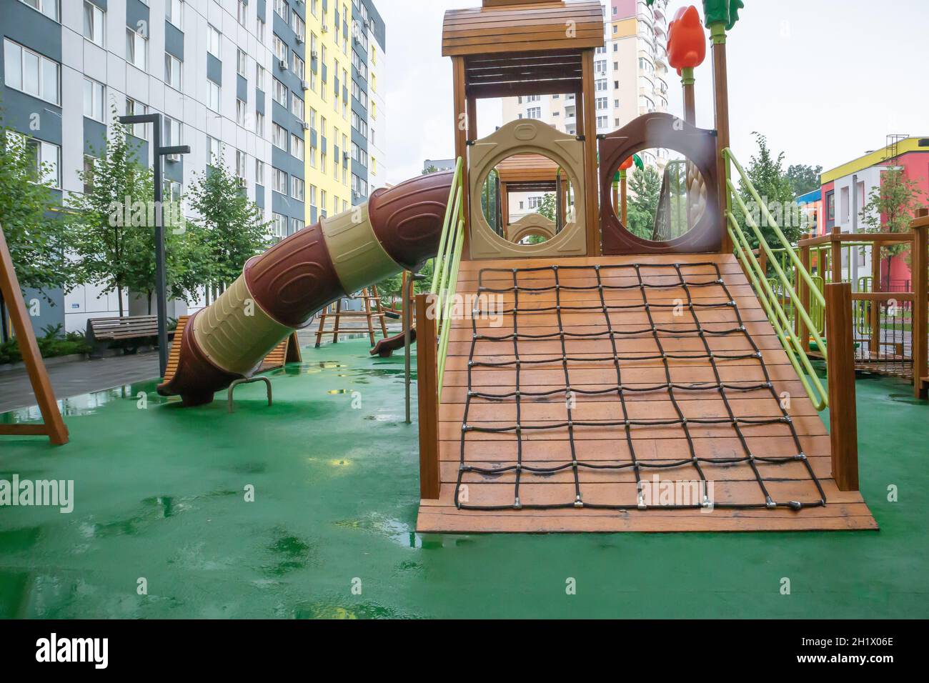 A courtyard of high-rise buildings with a modern and large playground ...