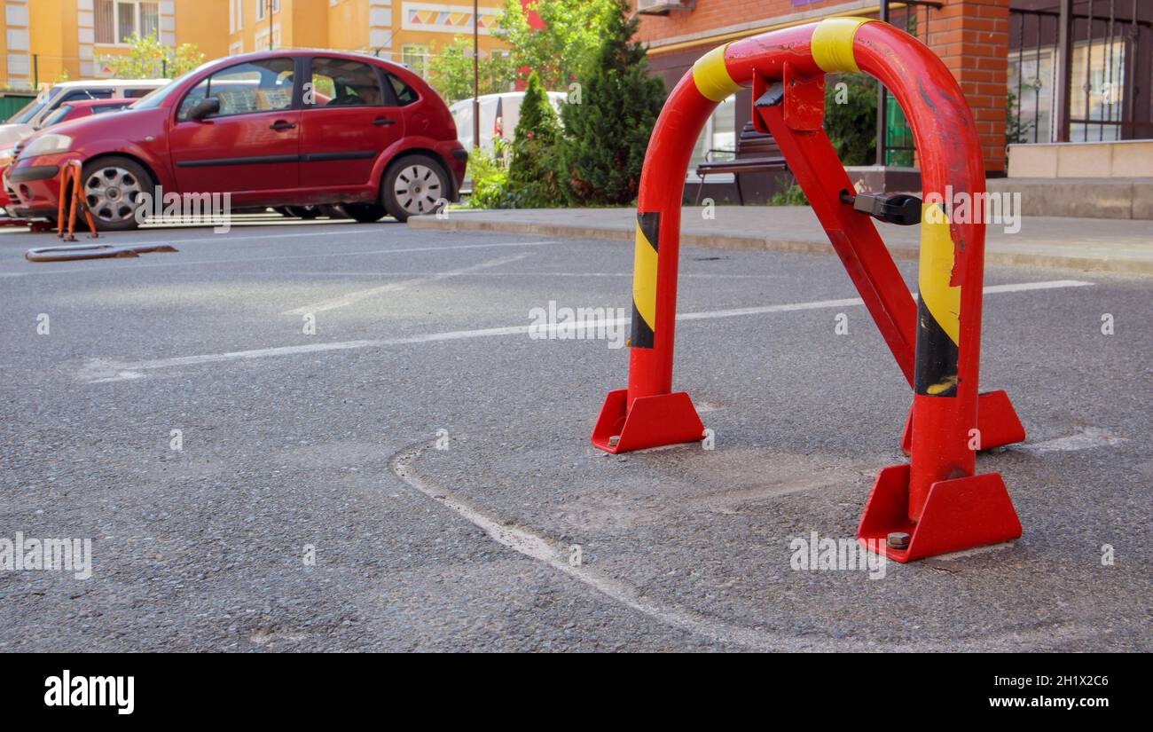 Manual red metal parking barrier with lock. Parking lock device ...