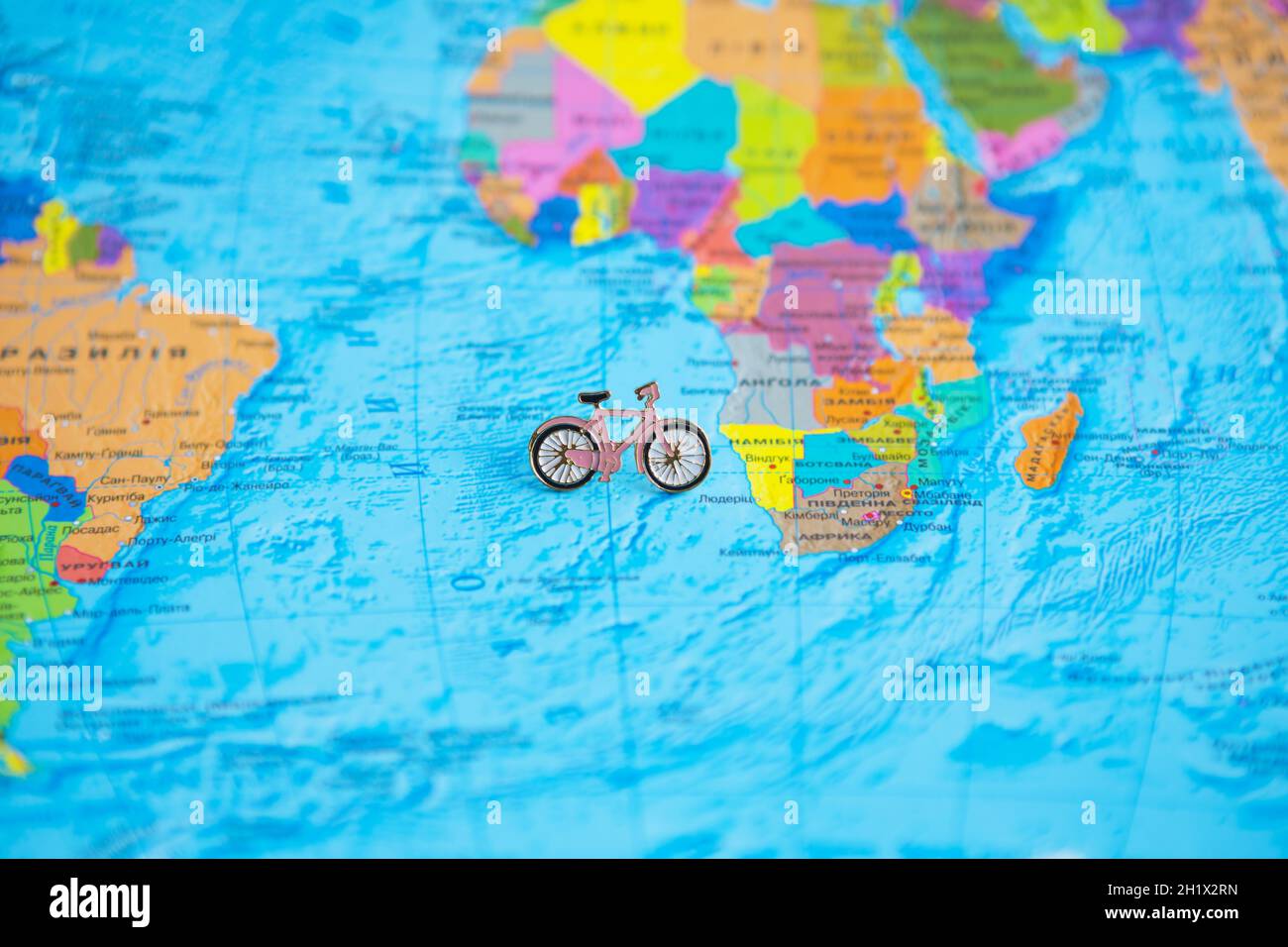 colorful mini bicycle on the world map Stock Photo - Alamy