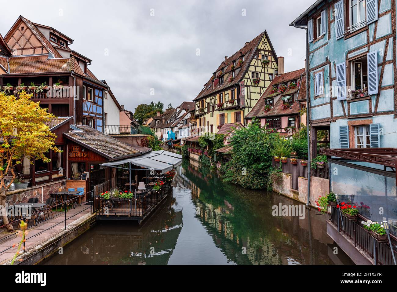 Colorful historic houses by the lake and bridge in Colmar France Stock ...