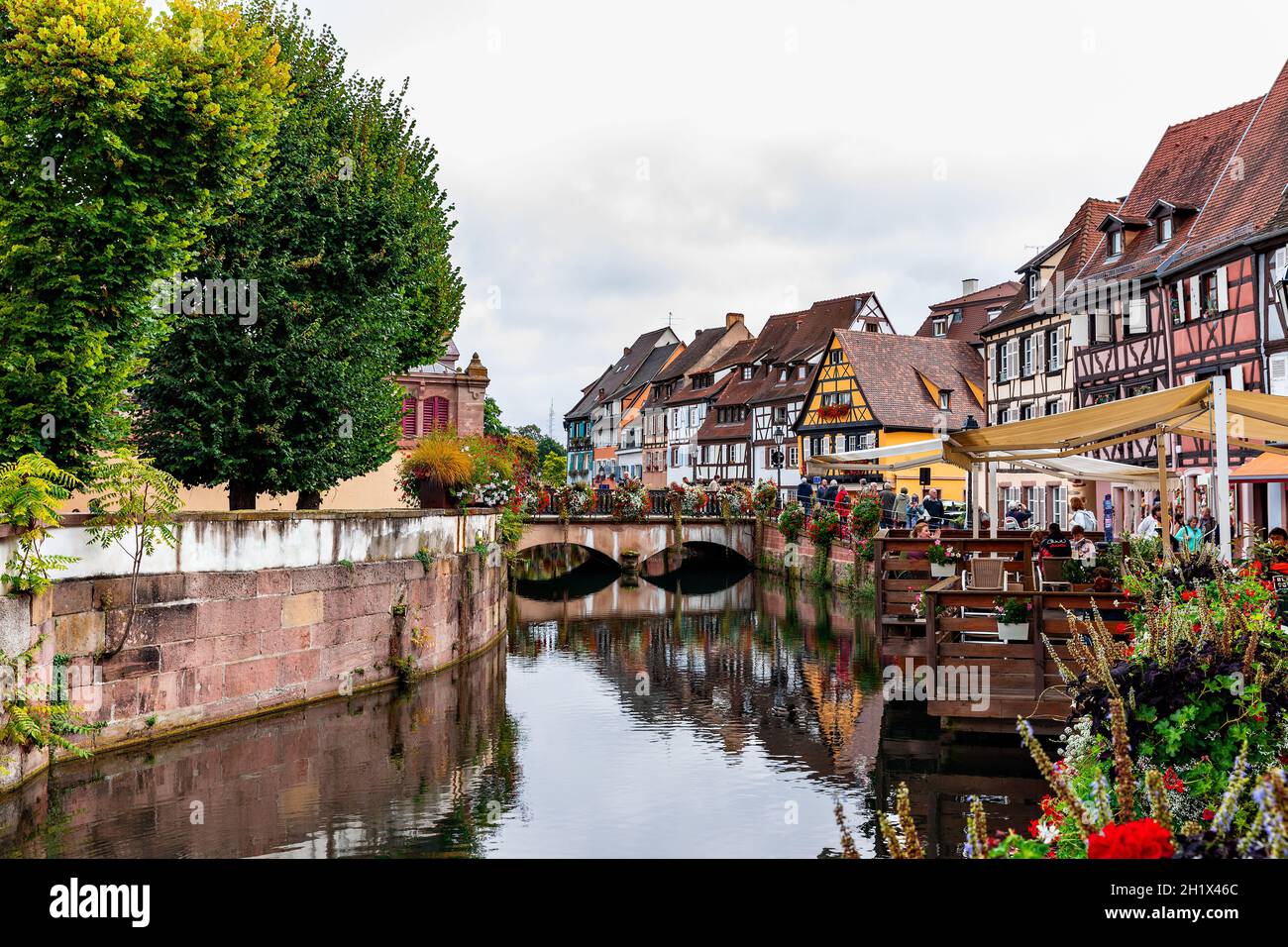 Colorful historic houses by the lake and bridge in Colmar France Stock ...