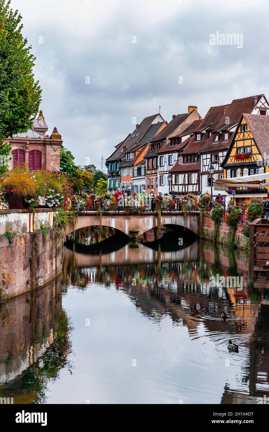 Colorful historic houses by the lake and bridge in Colmar France Stock ...