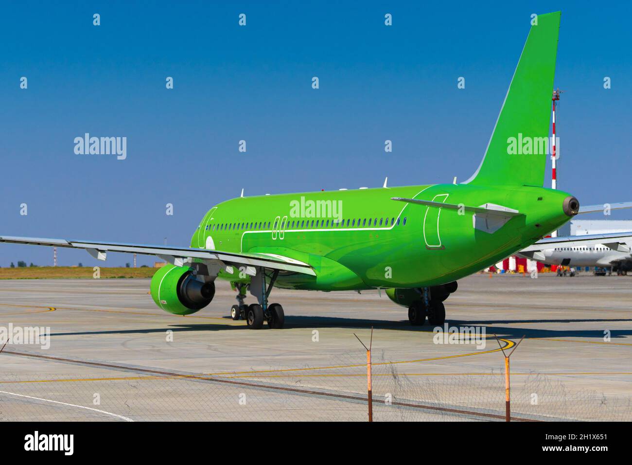 Green passenger airplane at the airport on sunny day Stock Photo - Alamy