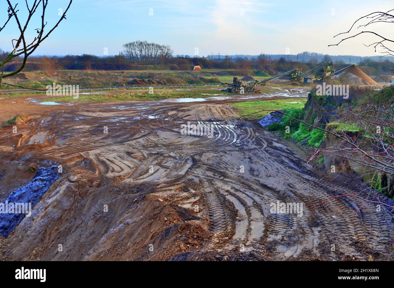 View into a gravel pit with piles of sand and tire tracks Stock Photo ...