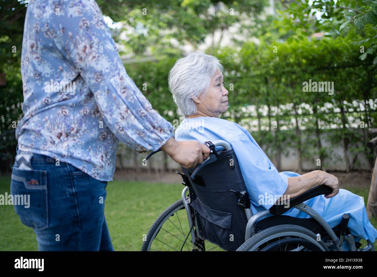 Doctor help and care Asian senior or elderly old lady woman patient sitting on wheelchair at ...